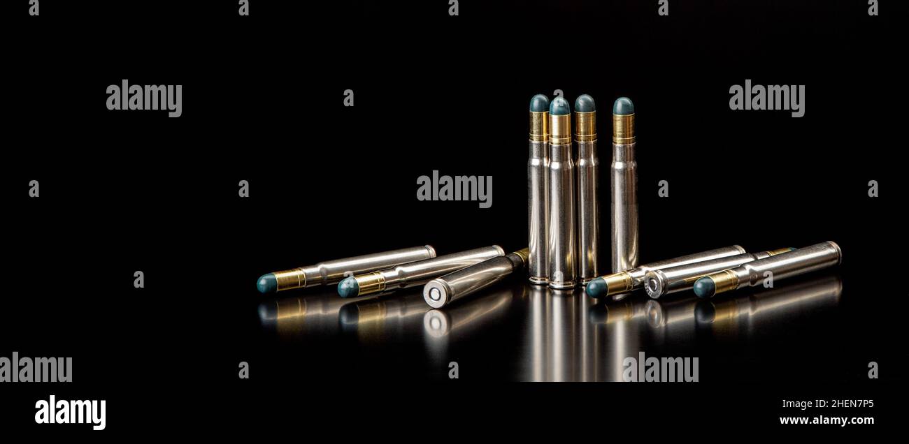 Bullet isolated on black background with reflexion. Rifle bullets close ...