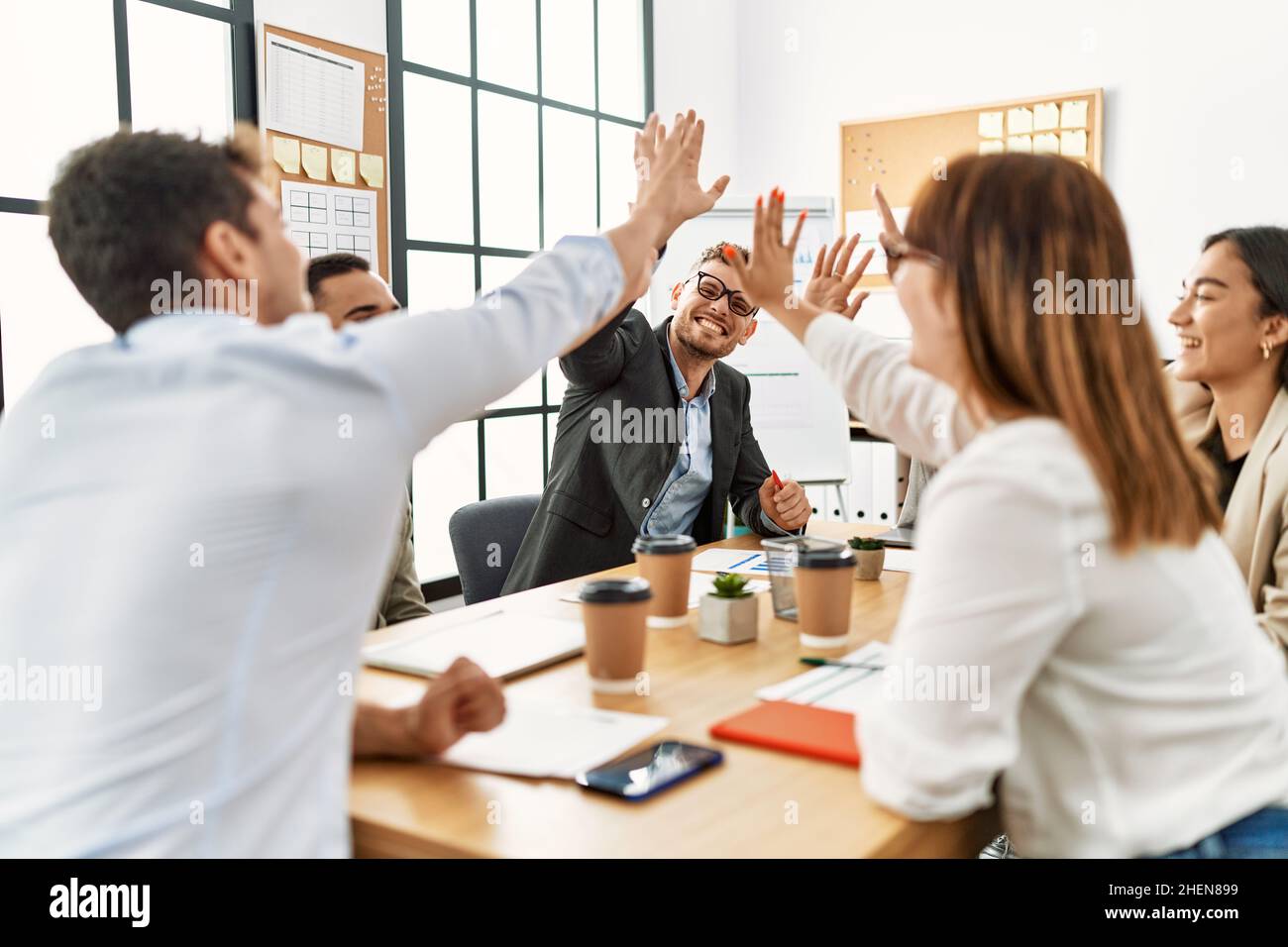 Group of business workers smiling happy celebrating high five at the ...