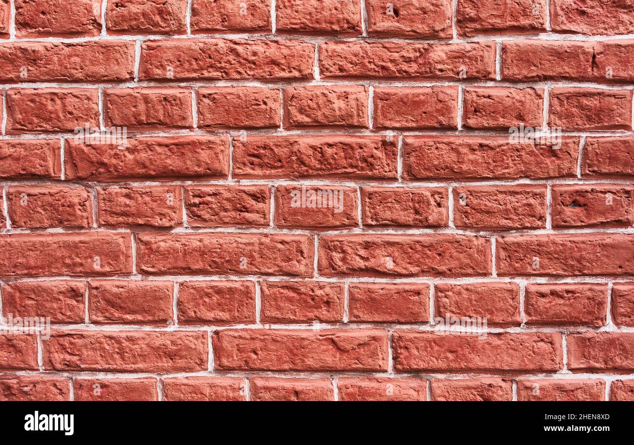 Painted red brick wall surface background Stock Photo - Alamy