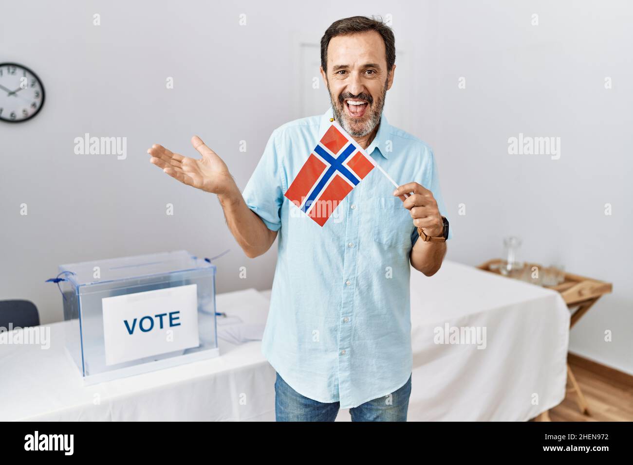 Middle age man with beard at political campaign election holding norway ...