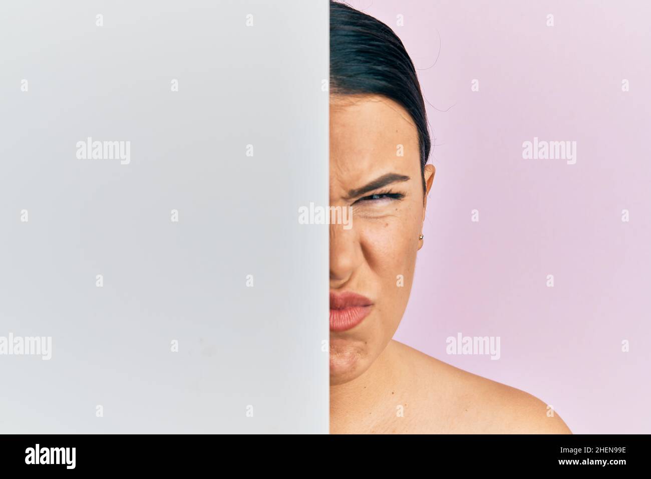 Beautiful brunette woman holding blank empty banner covering half face ...