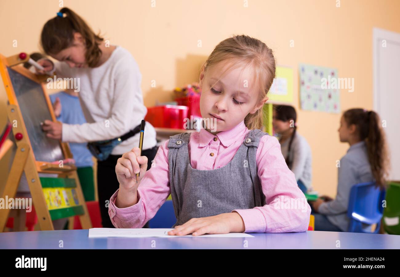 Schoolgirl drawing at break in school Stock Photo - Alamy