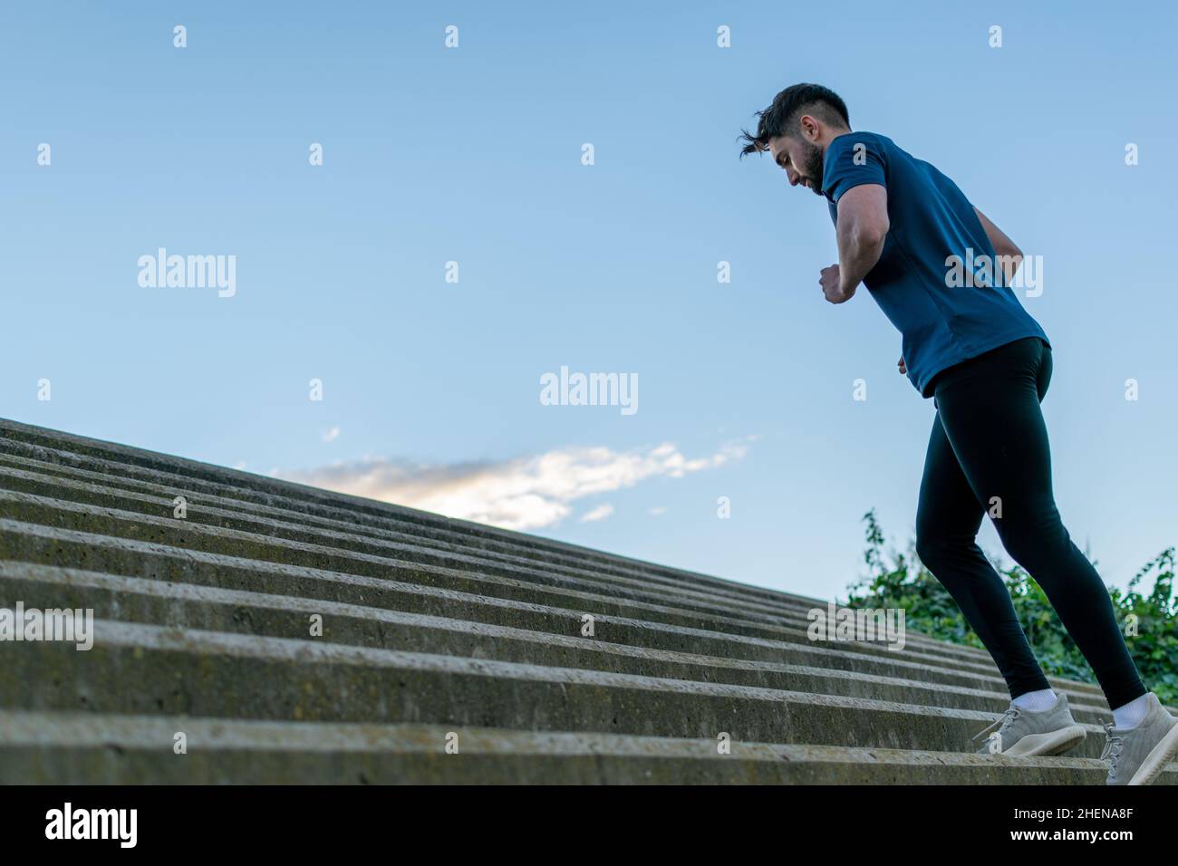 Young man climbing stairs in the park Stock Photo - Alamy
