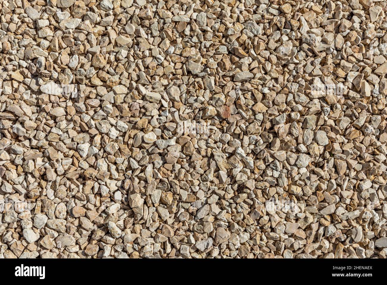 small gravel stones in sun give a harmonic background Stock Photo - Alamy