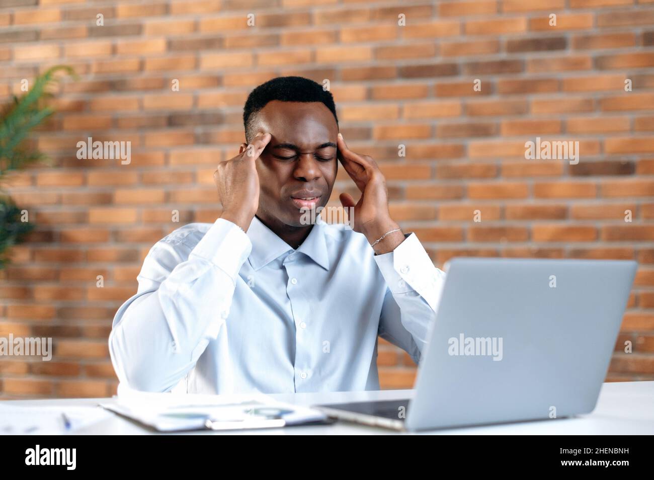 Migraine, fatigue. African American office worker, manager, programmer ...