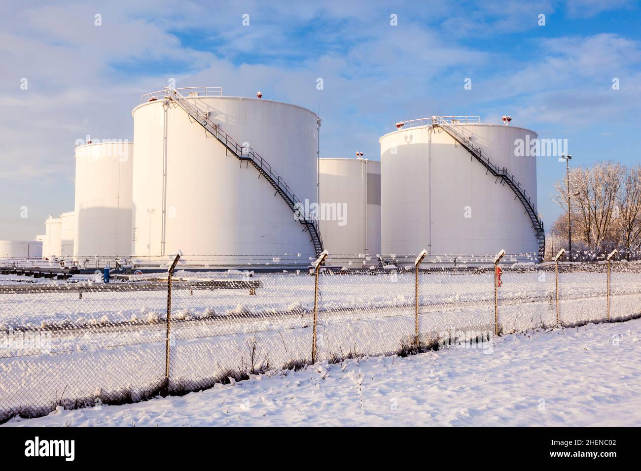 white tanks in tank farm with iron staircase in snow Stock Photo - Alamy