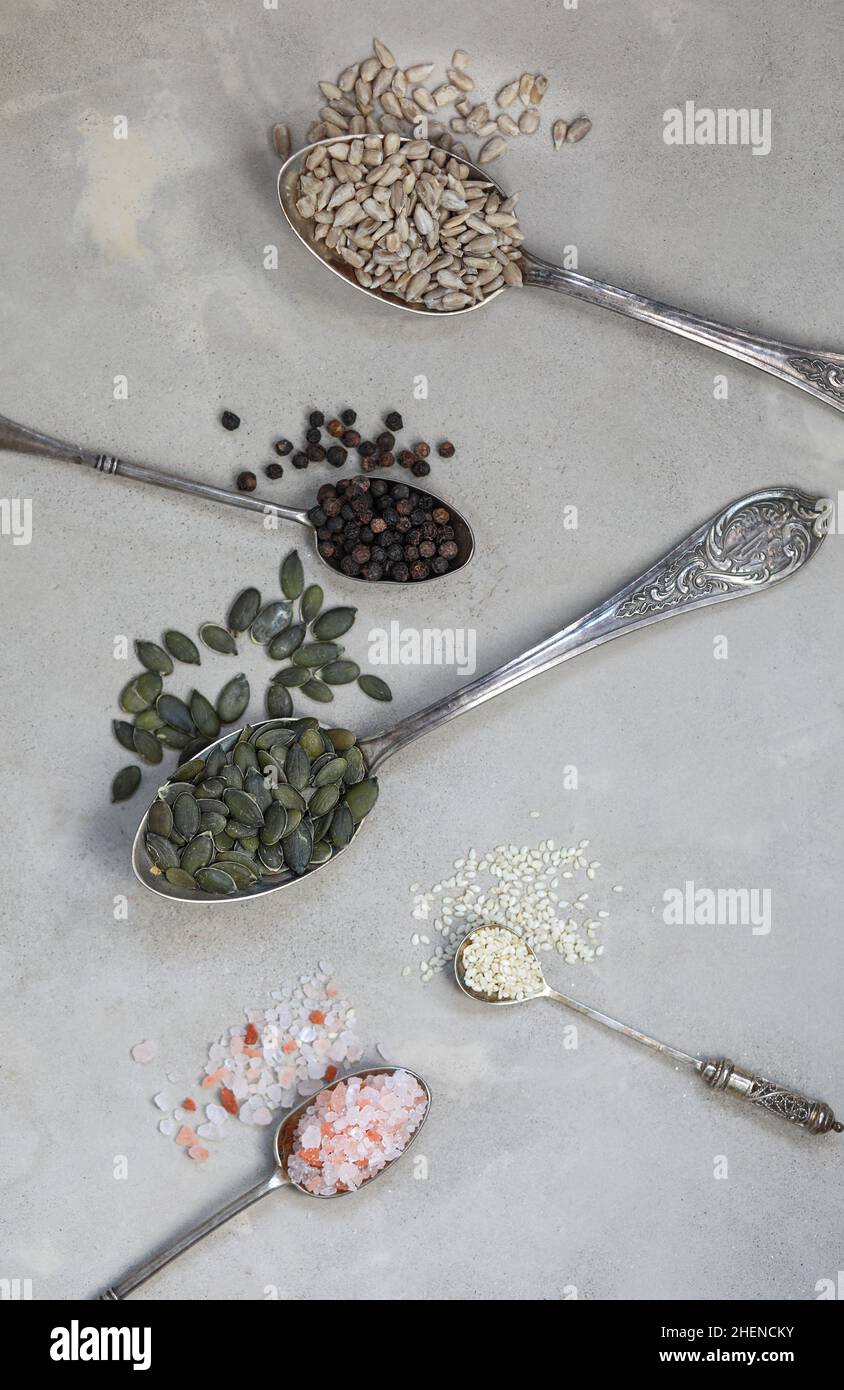 Collection of spices and seeds on a spoons on gray background Stock Photo - Alamy