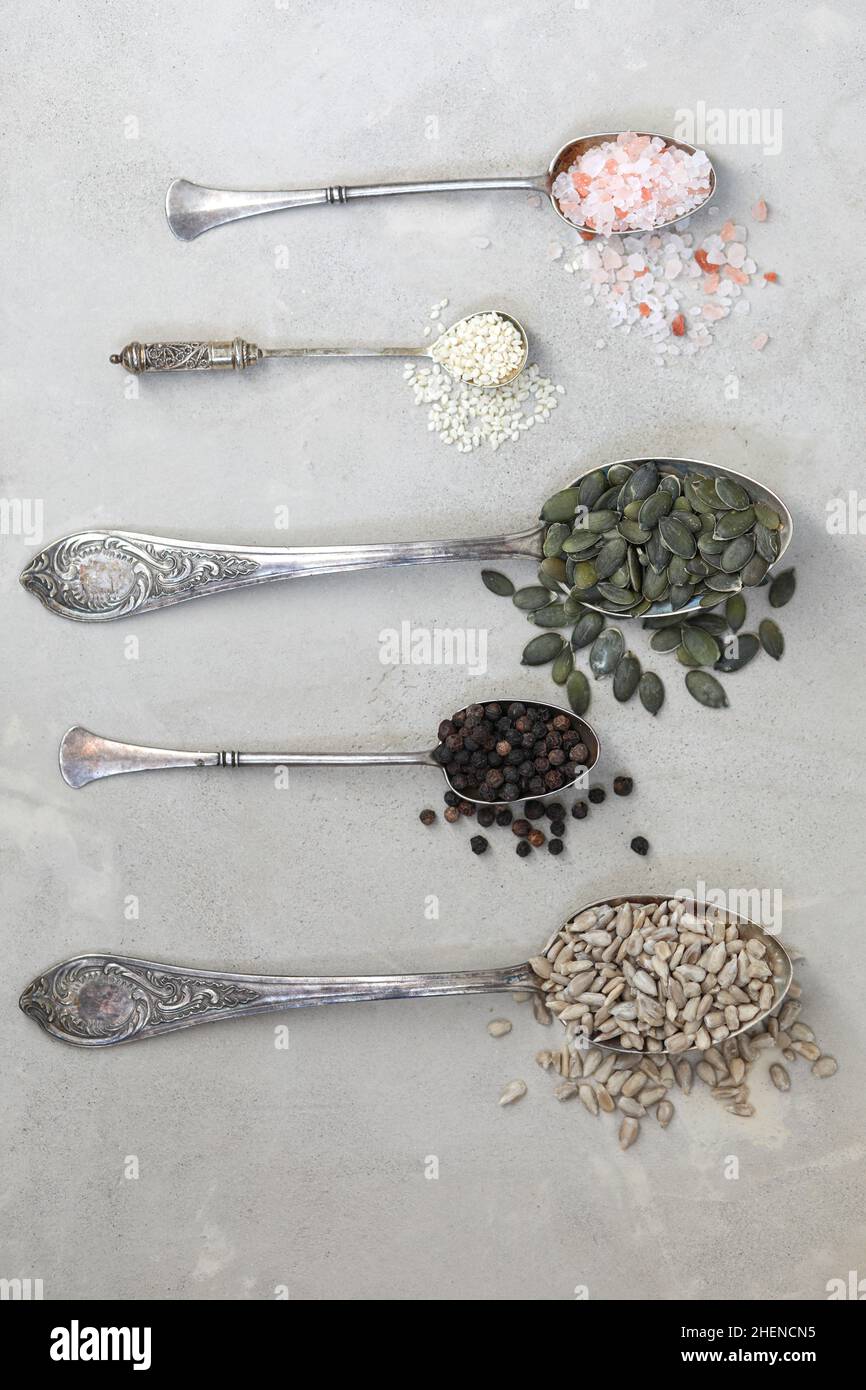 Collection of spices and seeds on a spoons on gray background Stock Photo - Alamy