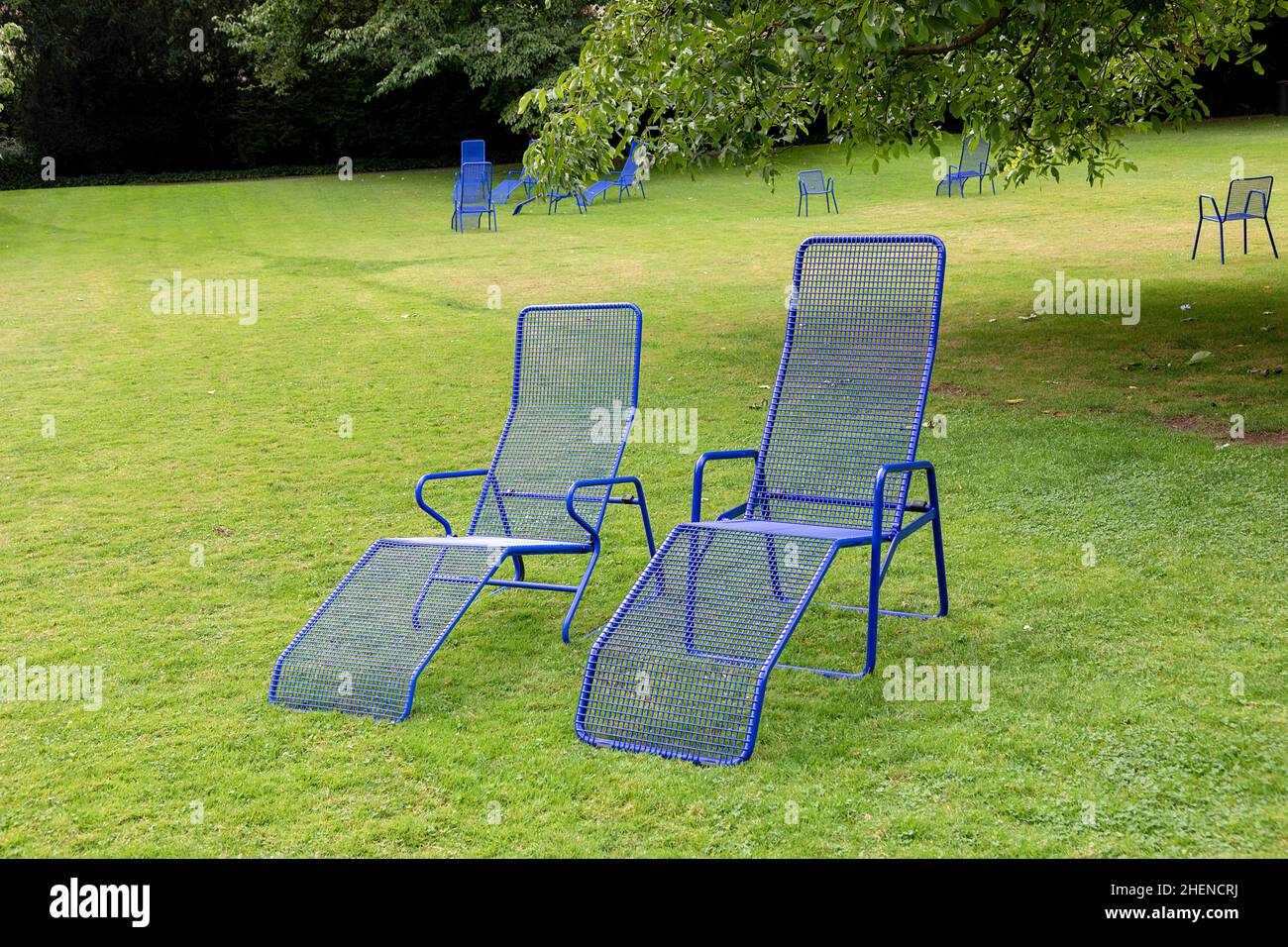empty blue chiar at a green meadow symbolizing loneliness in corona ...