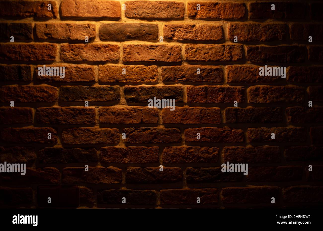 Brick wall illuminated by warm light from a lamp Stock Photo - Alamy