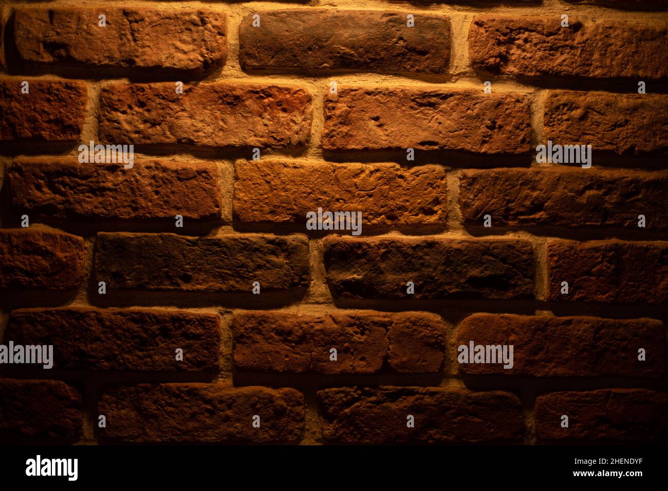 Brick wall illuminated by warm light from a lamp Stock Photo - Alamy