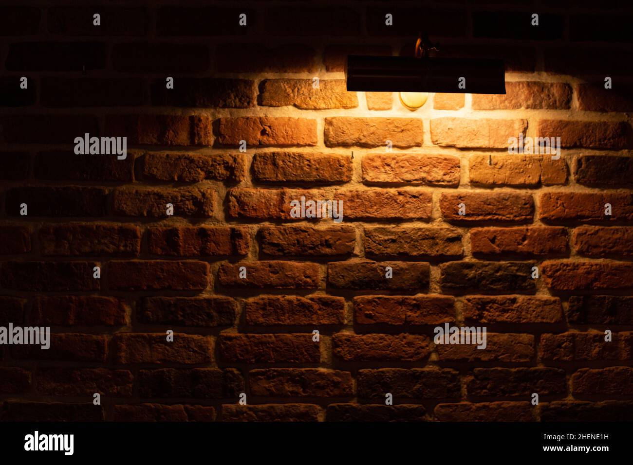 Brick wall illuminated by warm light from a lamp Stock Photo - Alamy