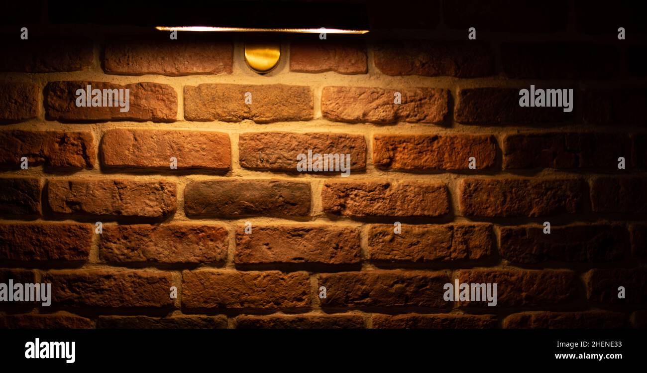 Brick wall illuminated by warm light from a lamp Stock Photo - Alamy