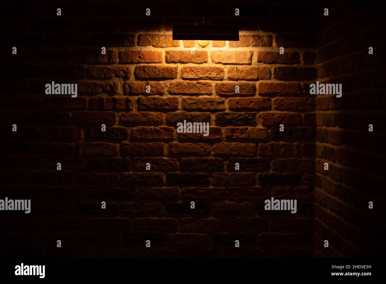 Brick wall illuminated by warm light from a lamp Stock Photo - Alamy