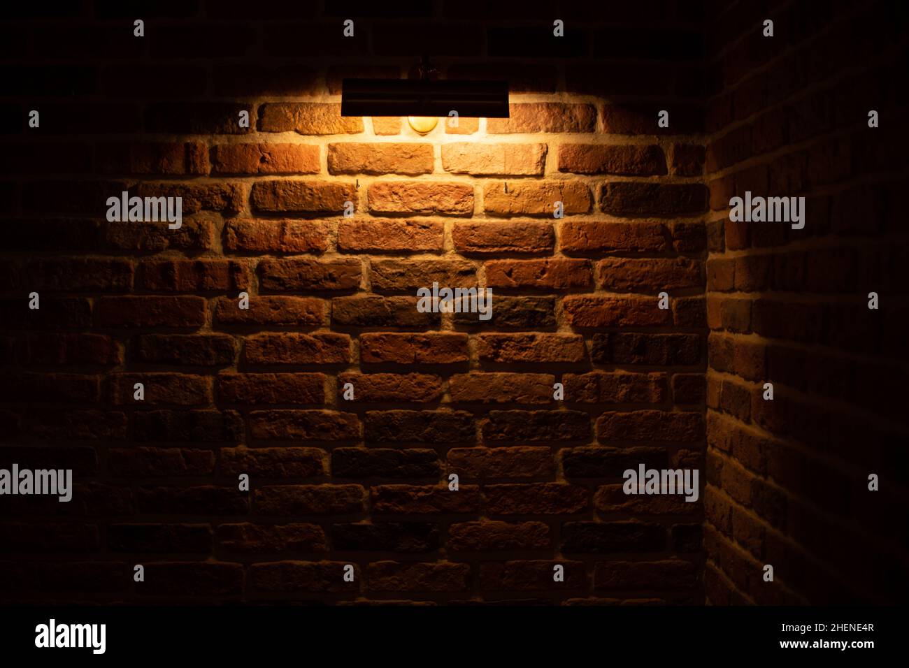 Brick wall illuminated by warm light from a lamp Stock Photo - Alamy