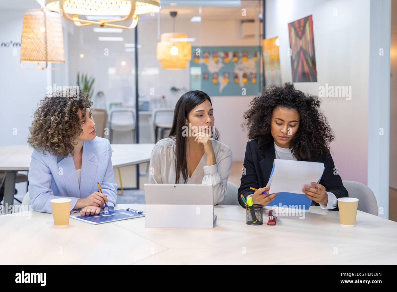 Multicultural business women having a reunion in the office and working ...
