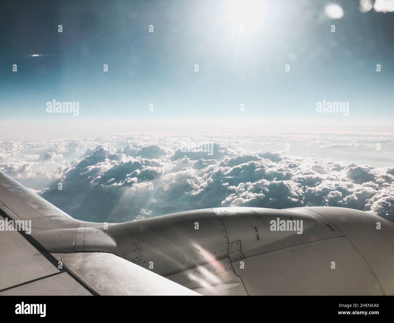 View of sky from above the clouds and airplane engine. Shot from ...