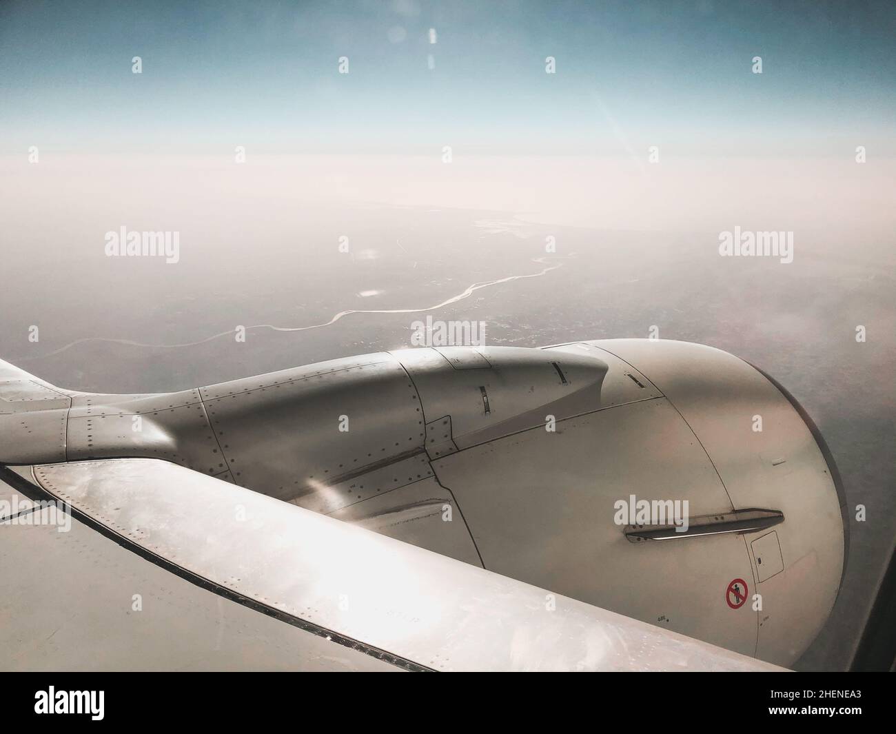 View of sky from in cloud and airplane engine with Nile river landscape ...