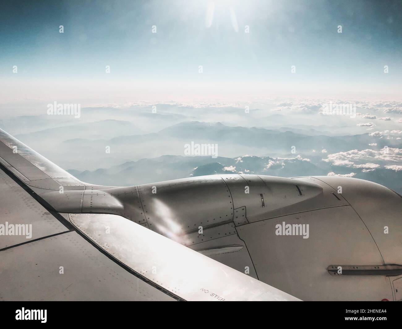 View of sky from above the clouds and airplane engine. Shot from ...