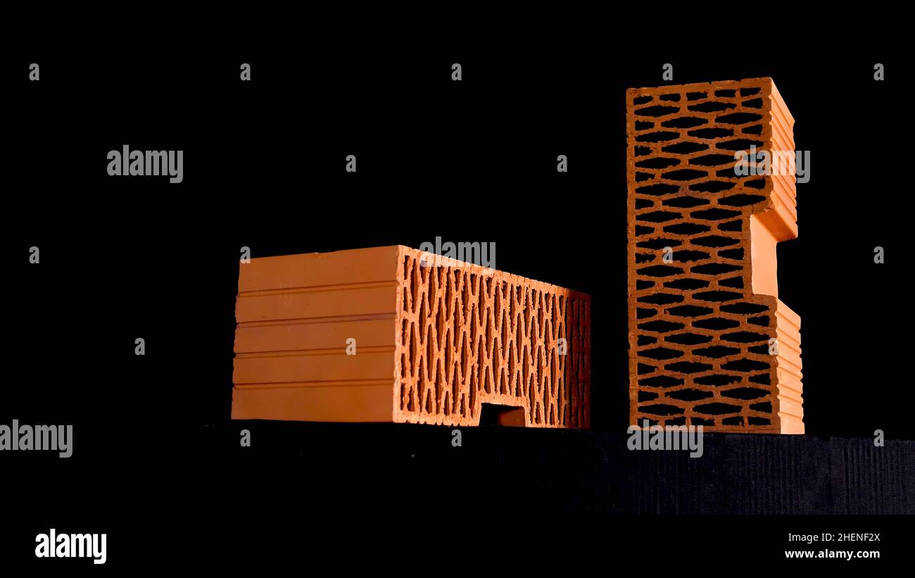 Close up of orange perforated bricks with round holes moving isolated ...