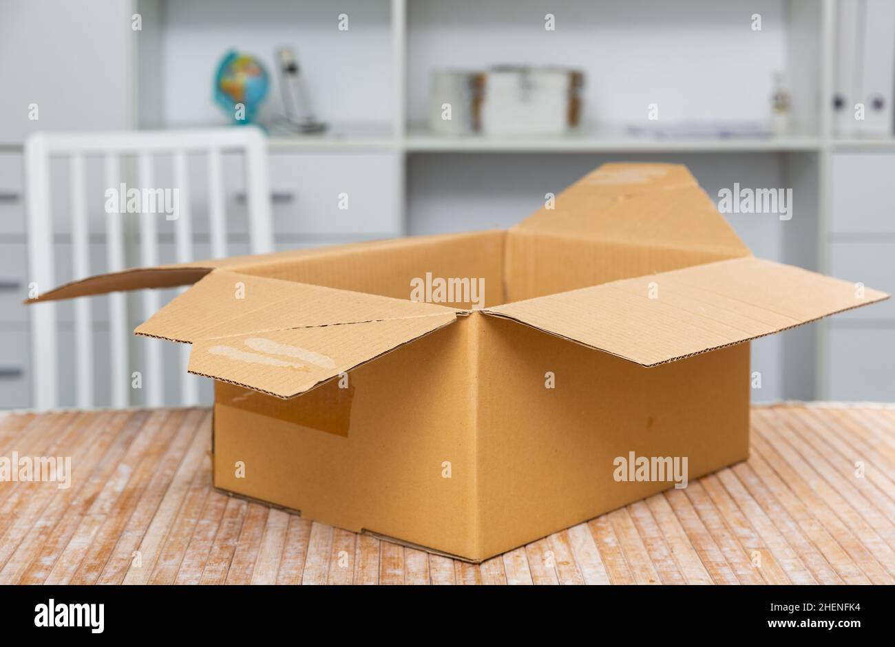 Cardboard box on table Stock Photo - Alamy