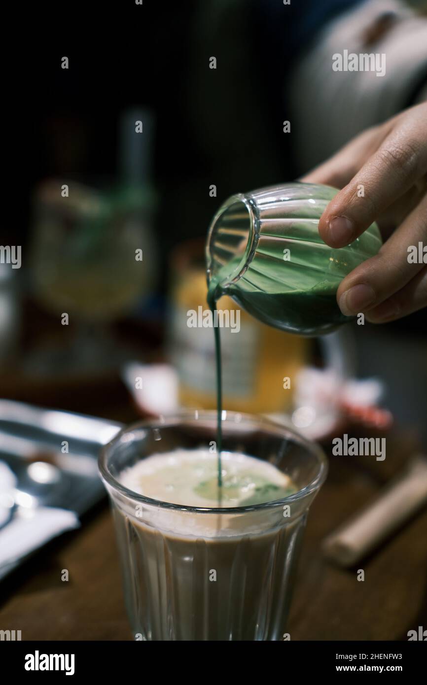 Matcha latte in hand Stock Photo - Alamy