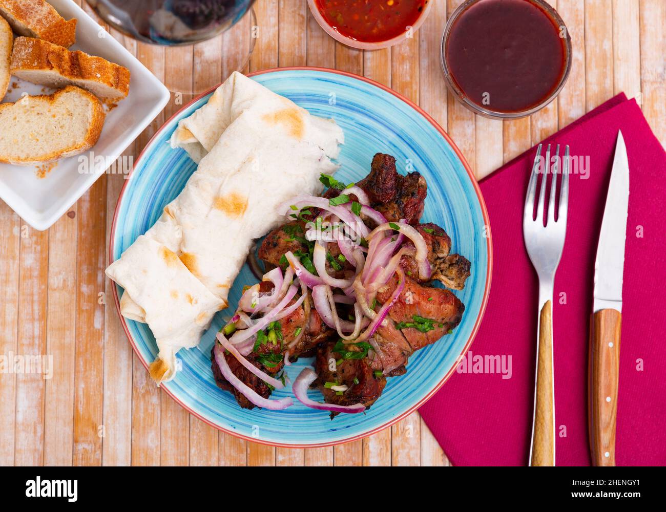 Grilled pork meat shashlik with marinated onion Stock Photo - Alamy