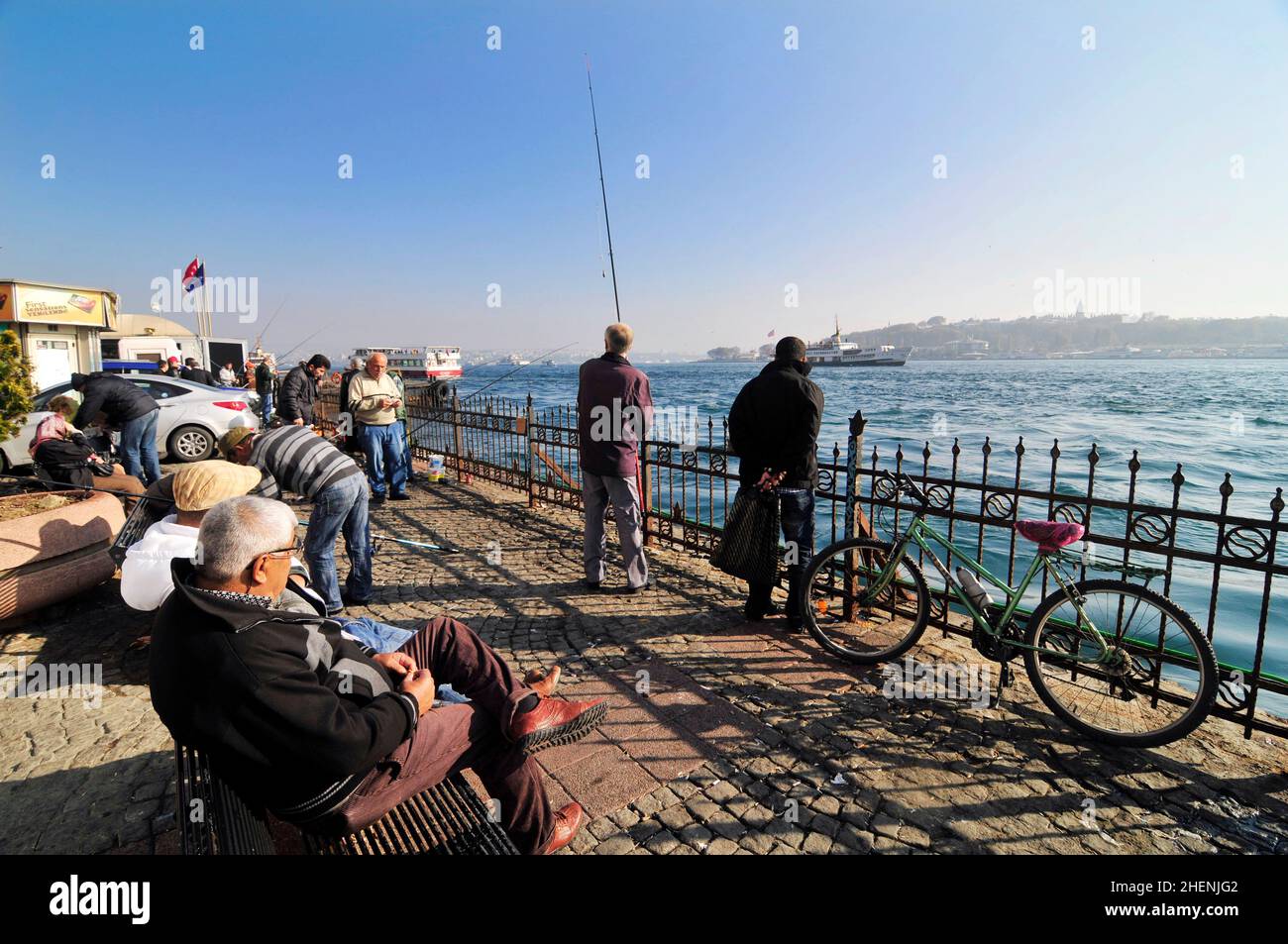Turkish men fishing from the bank of the Golden Horn in Istanbul ...