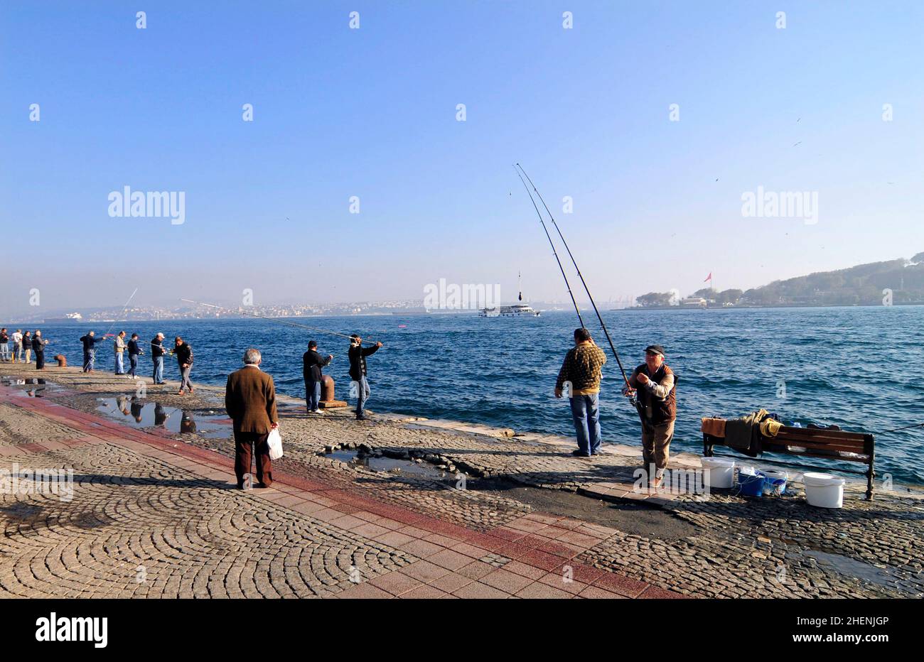 Turkish men fishing from the bank of the Golden Horn in Istanbul ...