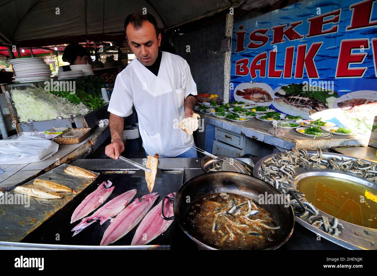 Preparing a Mackerel fish sandwich near the Galata bridge in Istanbul ...