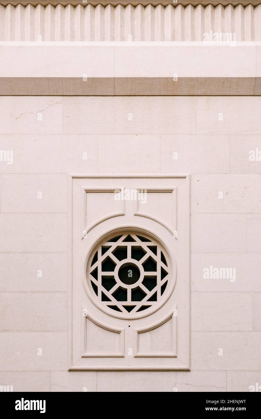Rose window with geometric patterns on a white church wall Stock Photo ...