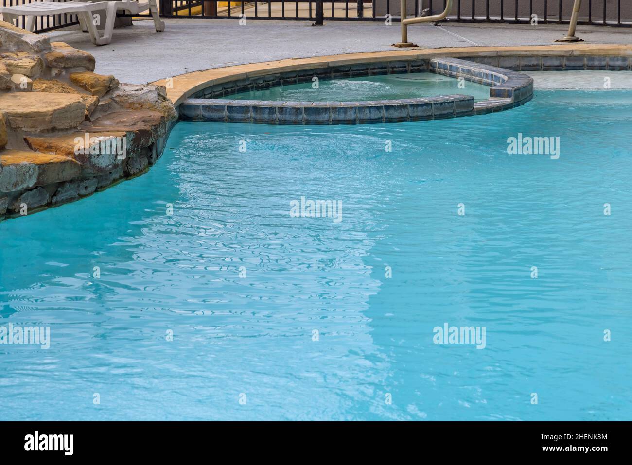 Relaxation in empty swimming pool with blue water Stock Photo - Alamy