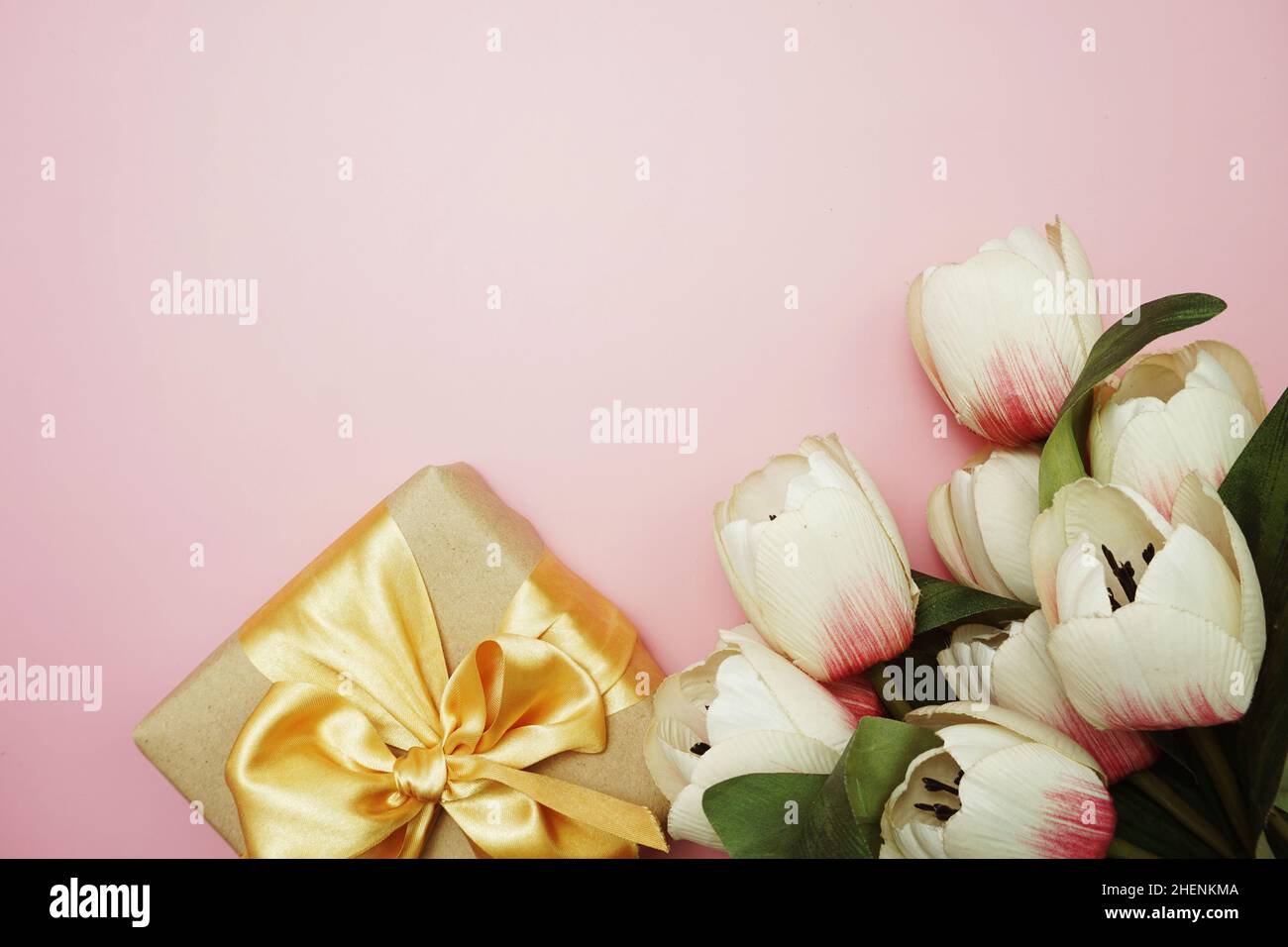 Gift box present and tulip flower bouquet on pink background Stock ...