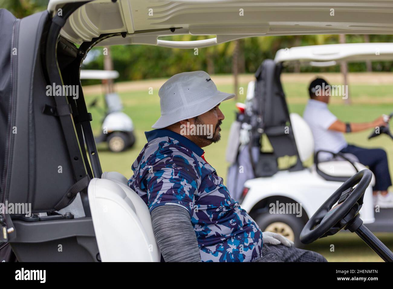 Golf player teeing off. Man hitting golf ball from tee box at Golf Club ...