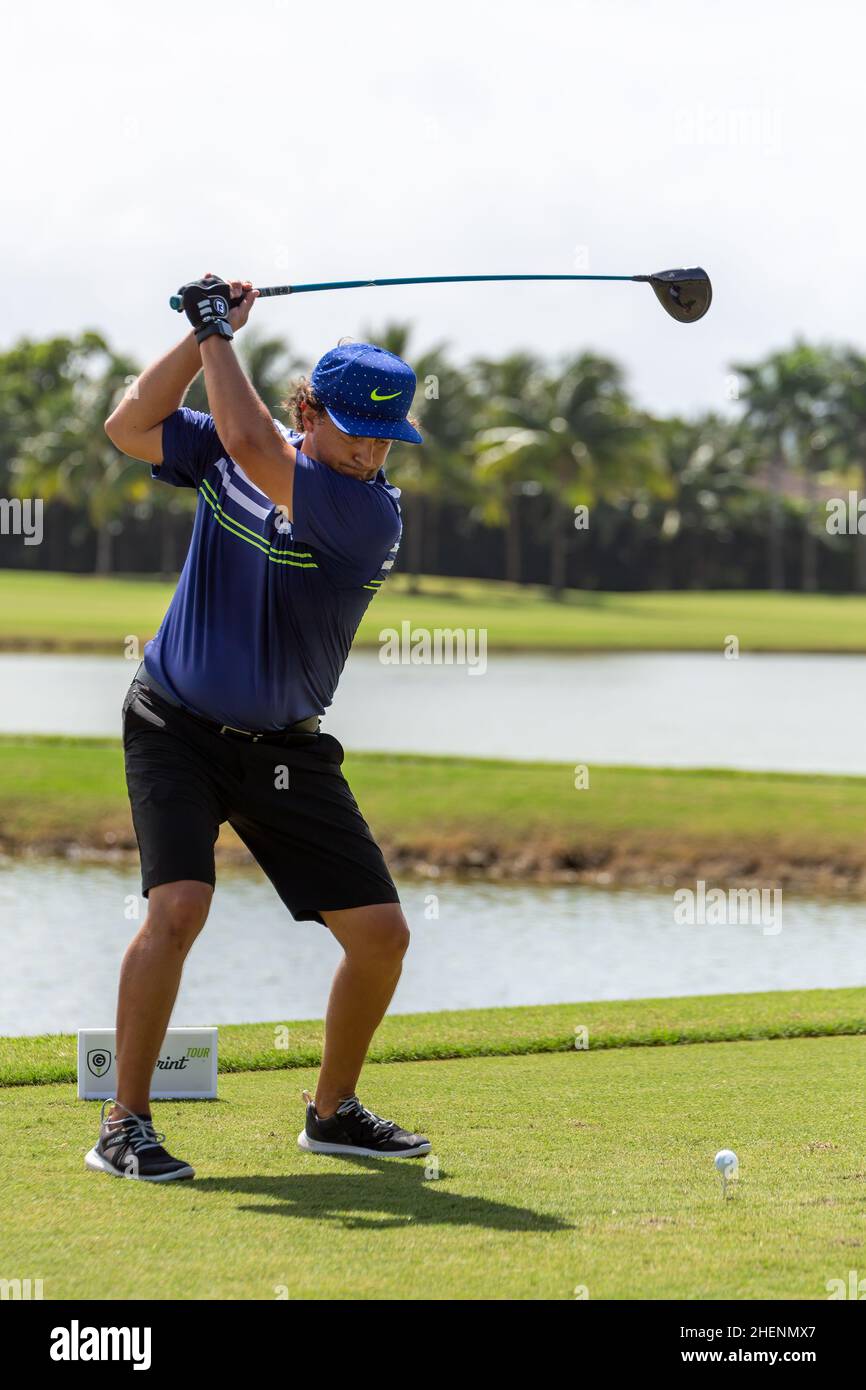 Golf player teeing off. Man hitting golf ball from tee box at Golf Club ...