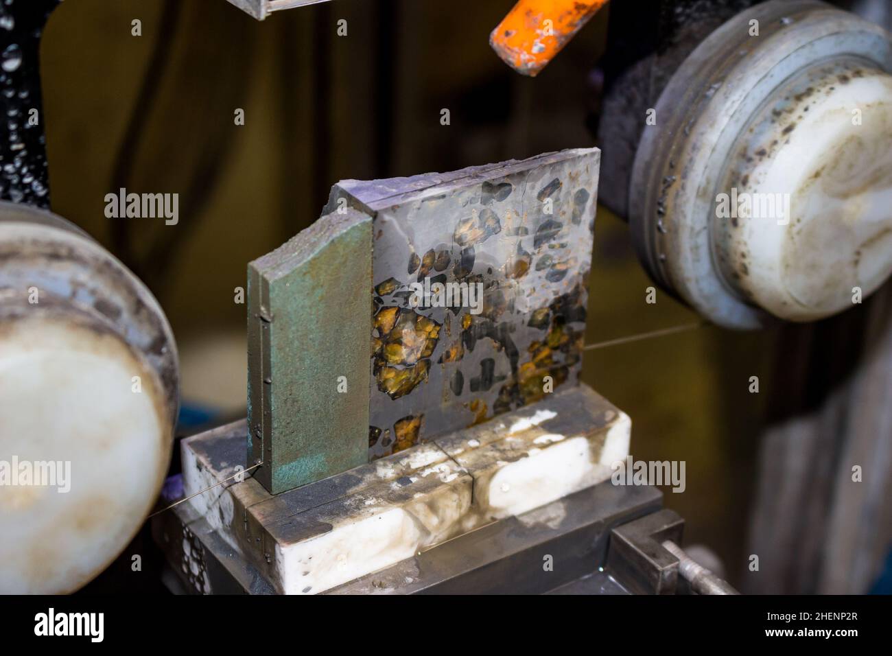 Sawing of the Pallasite iron-stone meteorite with a thin diamond thread ...