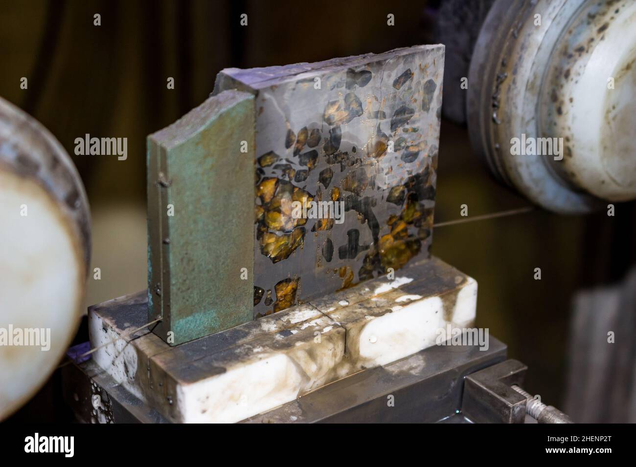Sawing of the Pallasite iron-stone meteorite with a thin diamond thread ...