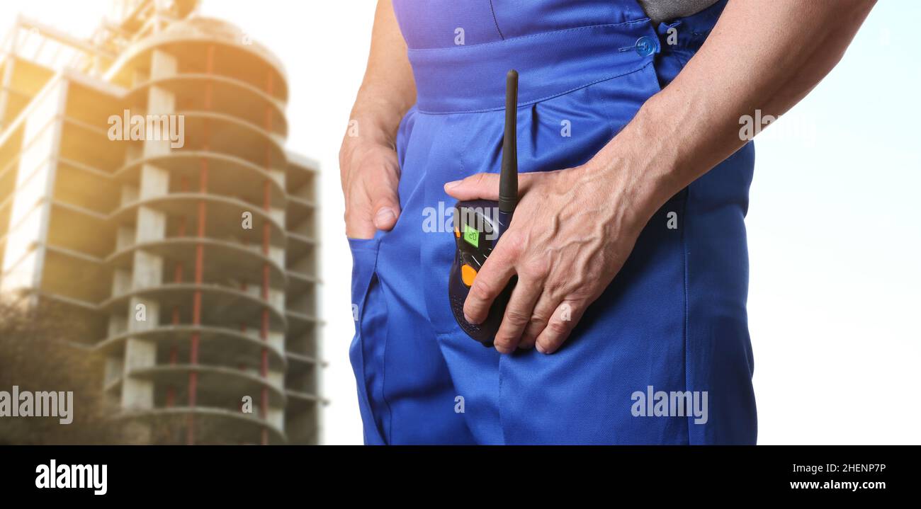 Male worker with radio transmitter at construction site Stock Photo - Alamy