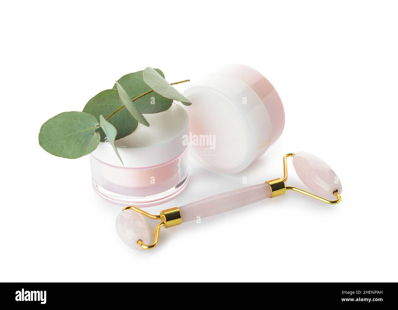 Face massage roller with cosmetic cream on white background Stock Photo ...