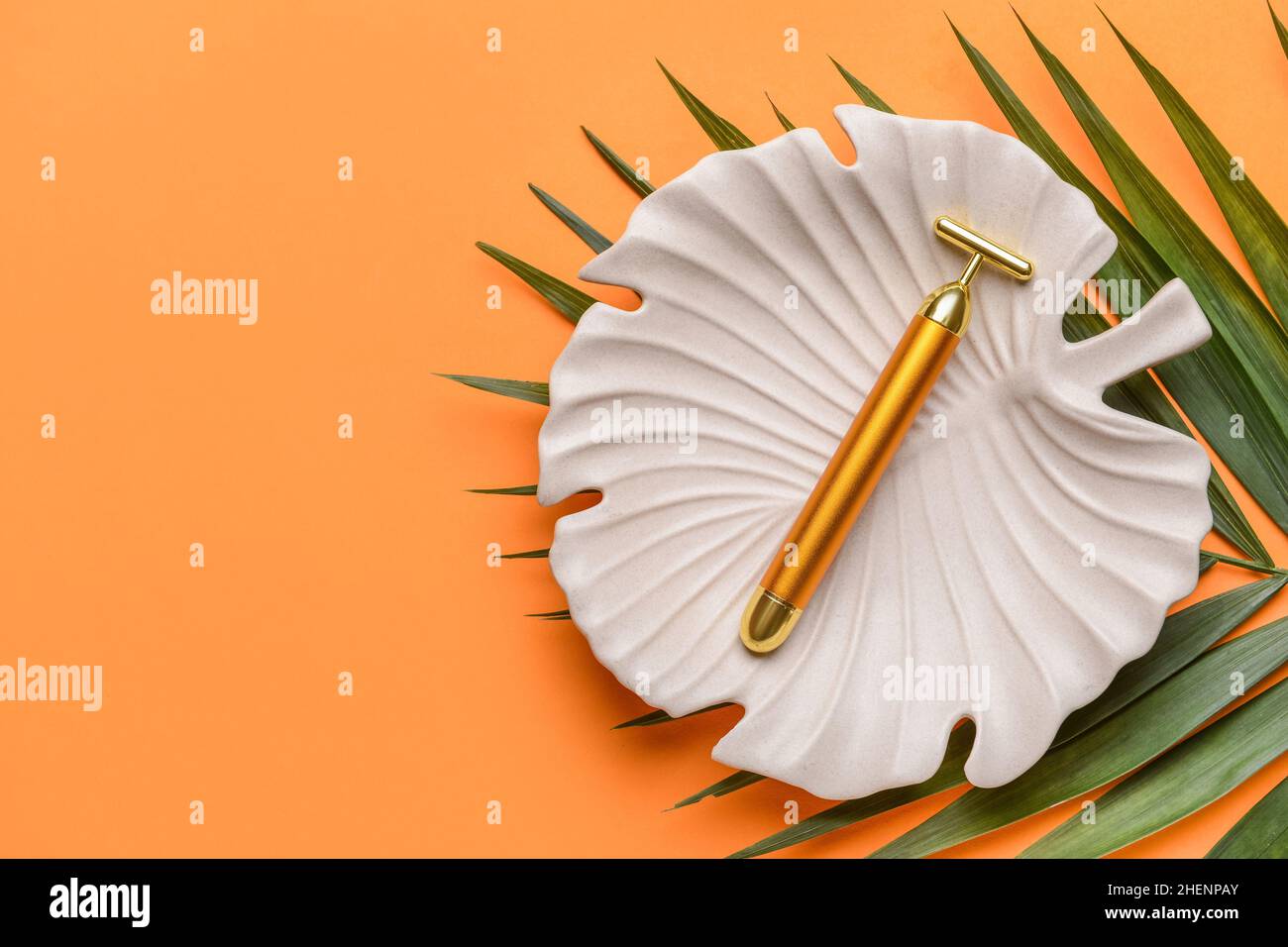 Face massage roller on color background Stock Photo - Alamy