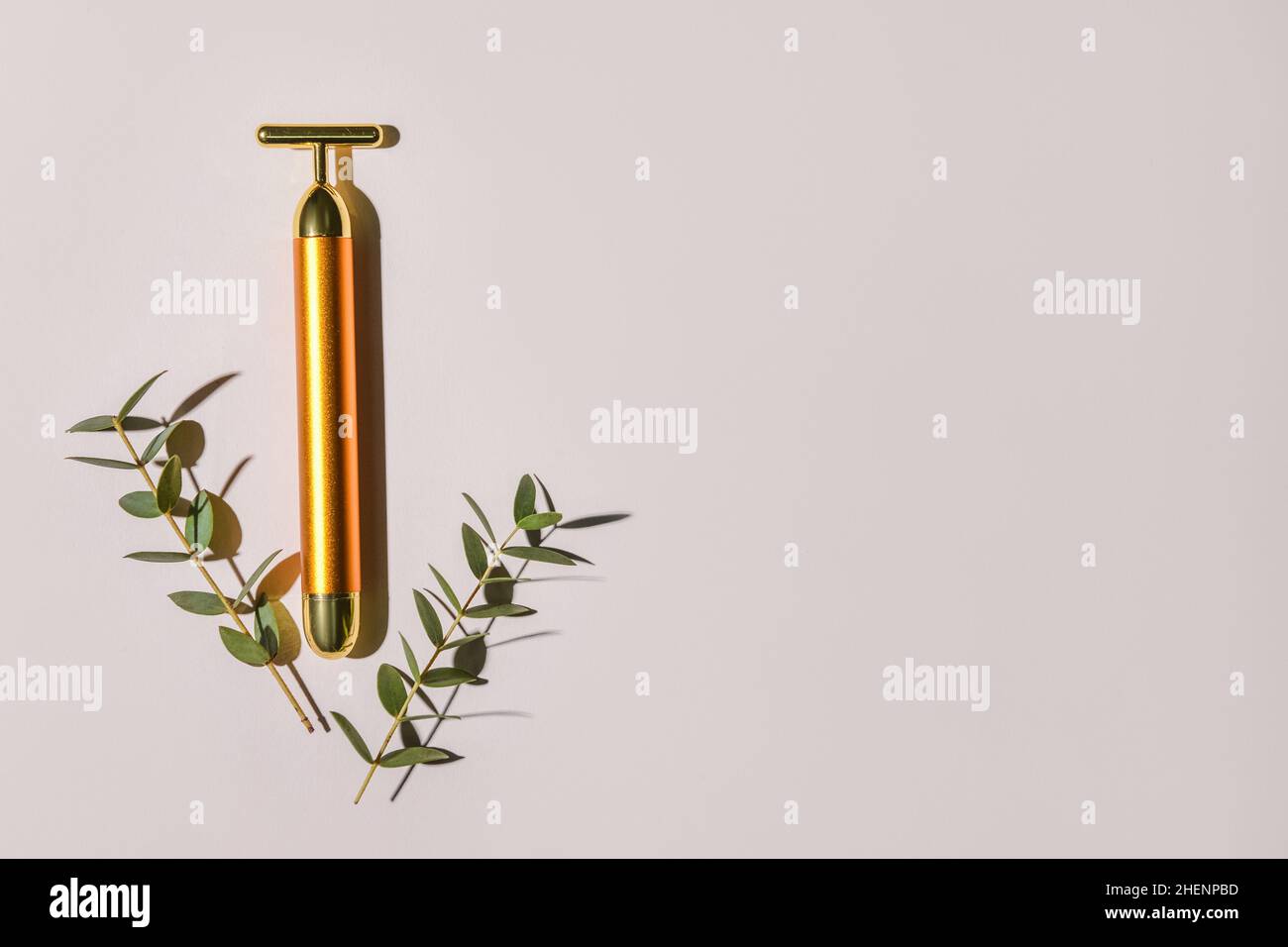 Face massage roller on light background Stock Photo - Alamy