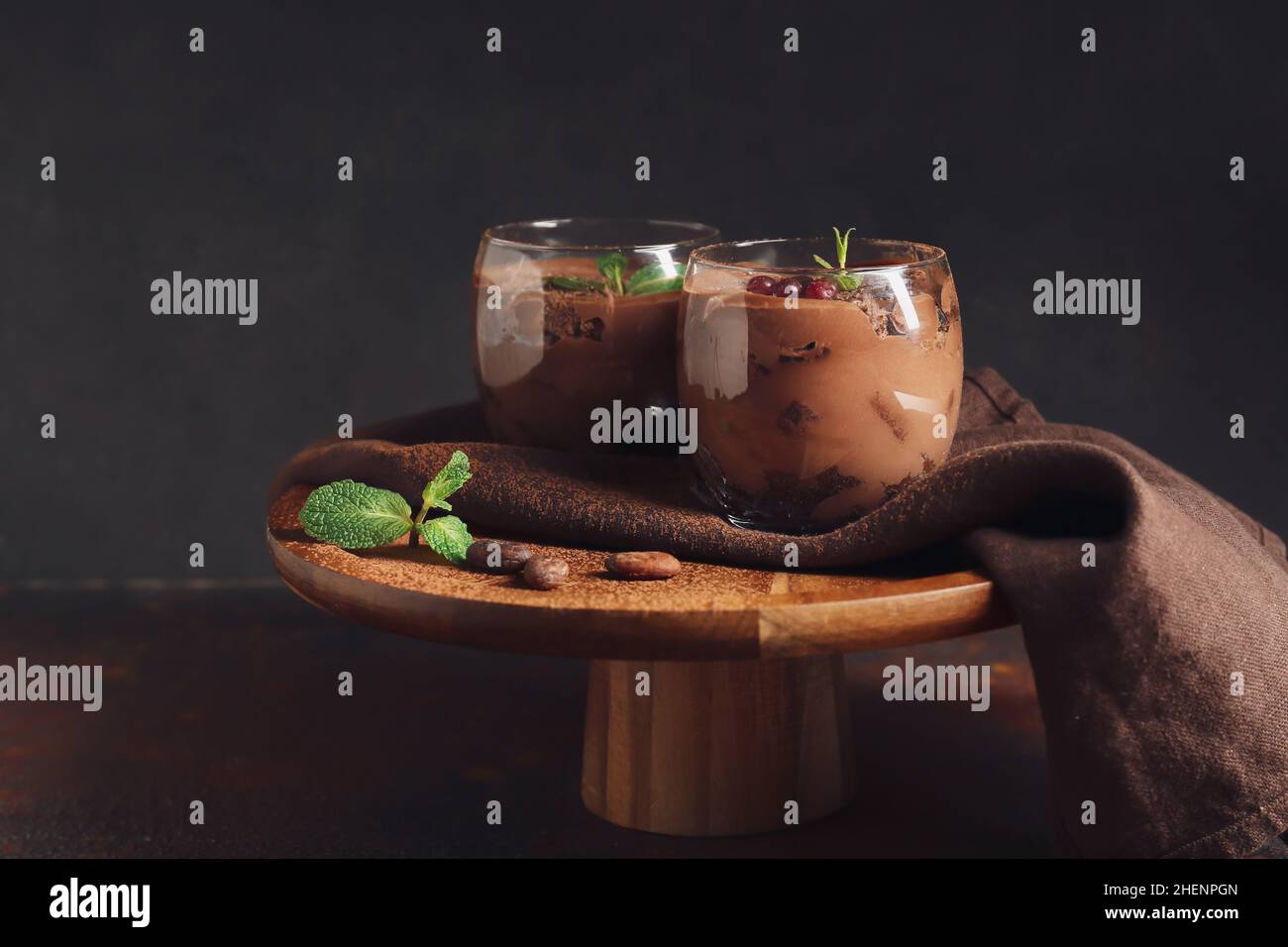 Stand with glasses of sweet cocoa dessert on dark background Stock ...