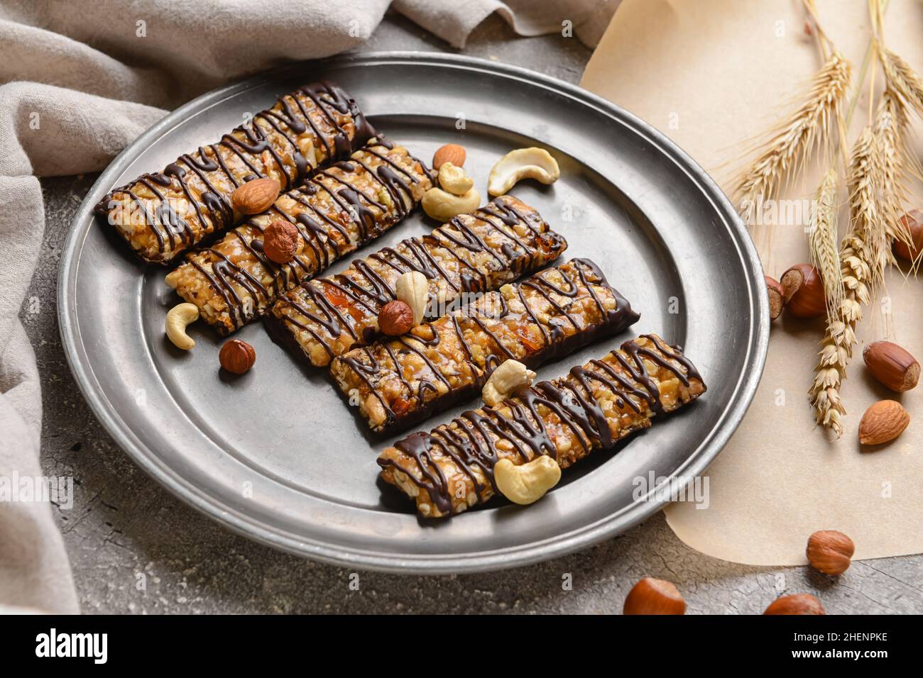 Tray with tasty chocolate nut bars on grunge background Stock Photo - Alamy