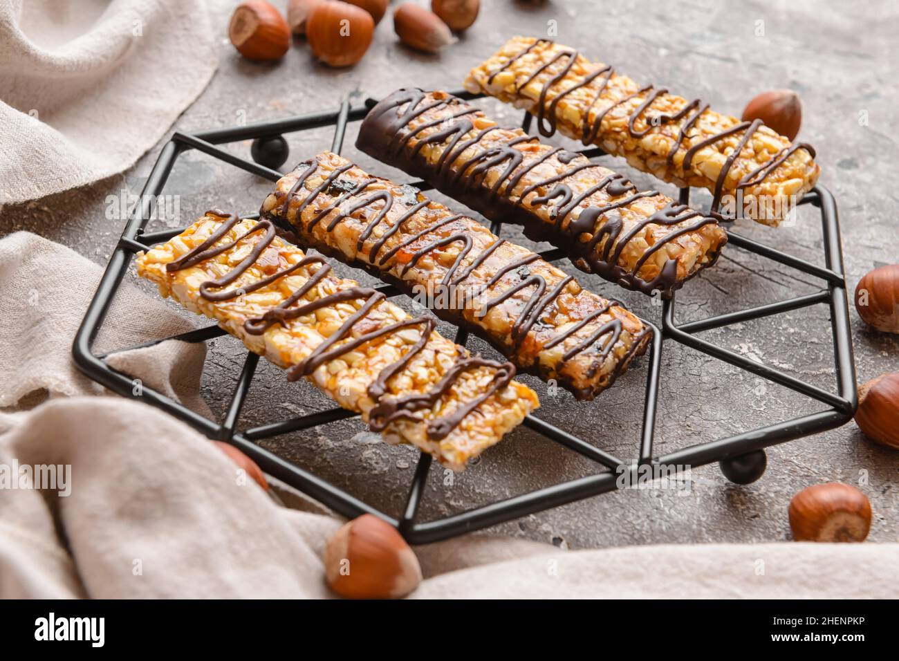 Rack with tasty chocolate nut bars on grunge background Stock Photo - Alamy