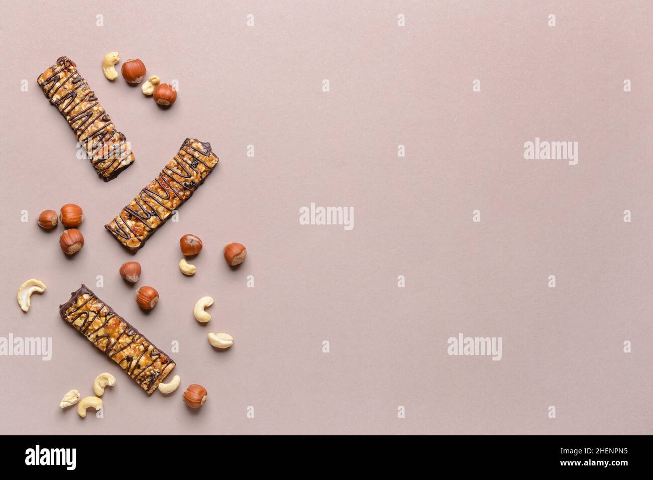 Tasty chocolate nut bars on grey background Stock Photo - Alamy