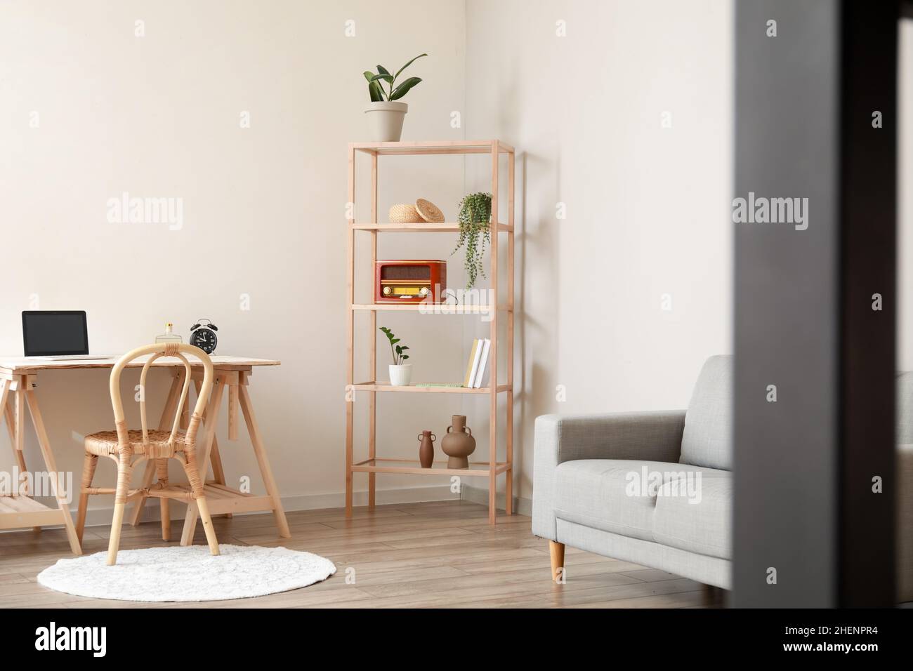 Interior of light room with modern workplace and shelving unit Stock ...