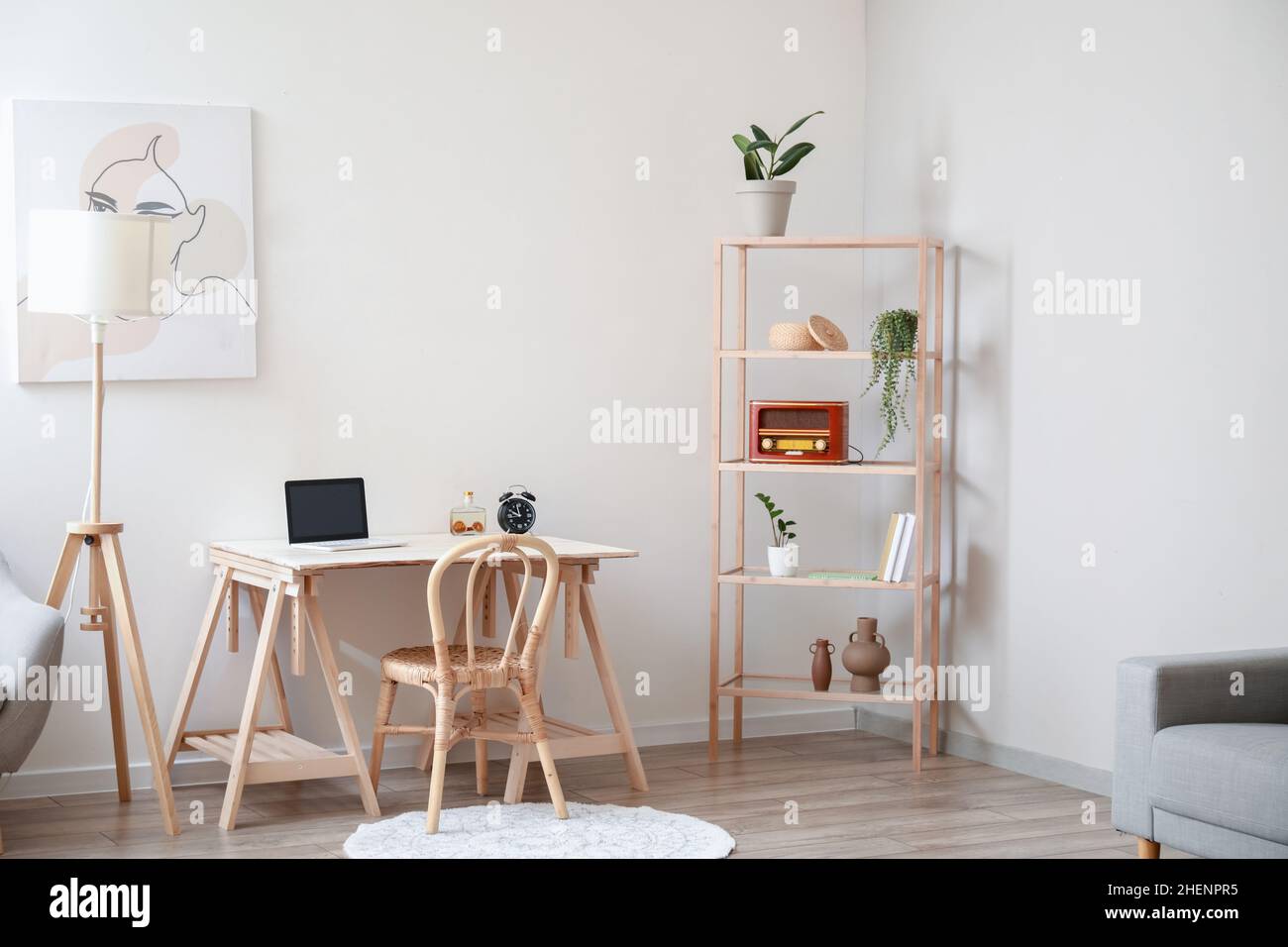 Interior of light room with modern workplace and shelving unit Stock ...