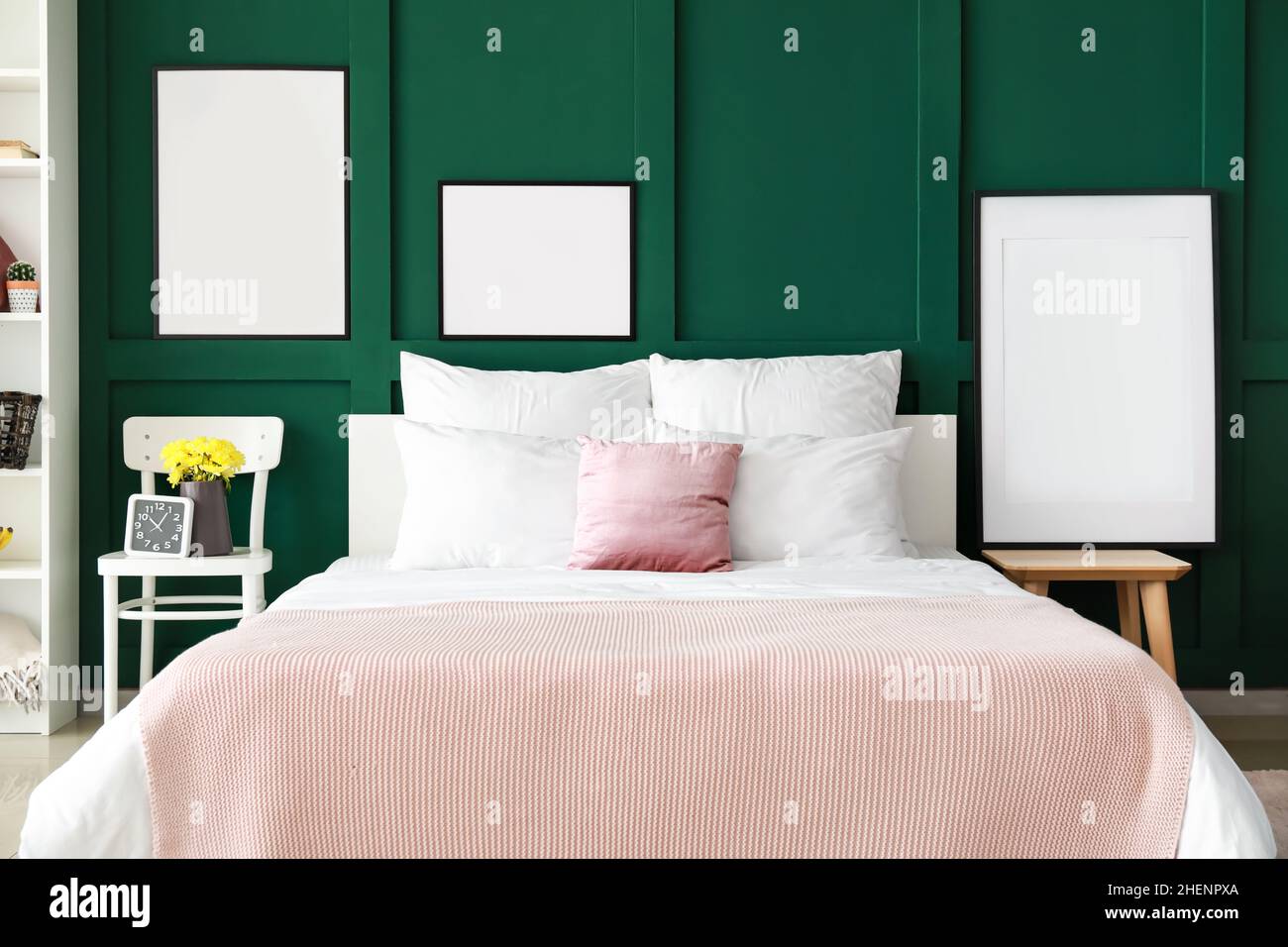 Stylish bedroom with comfy bed and blank posters Stock Photo - Alamy