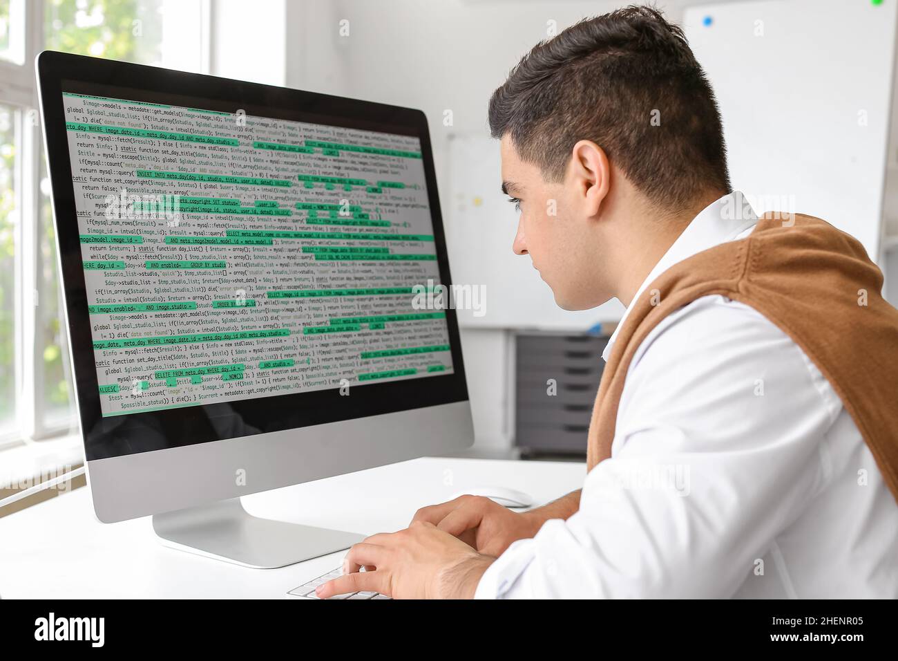 Male programmer working in office Stock Photo - Alamy