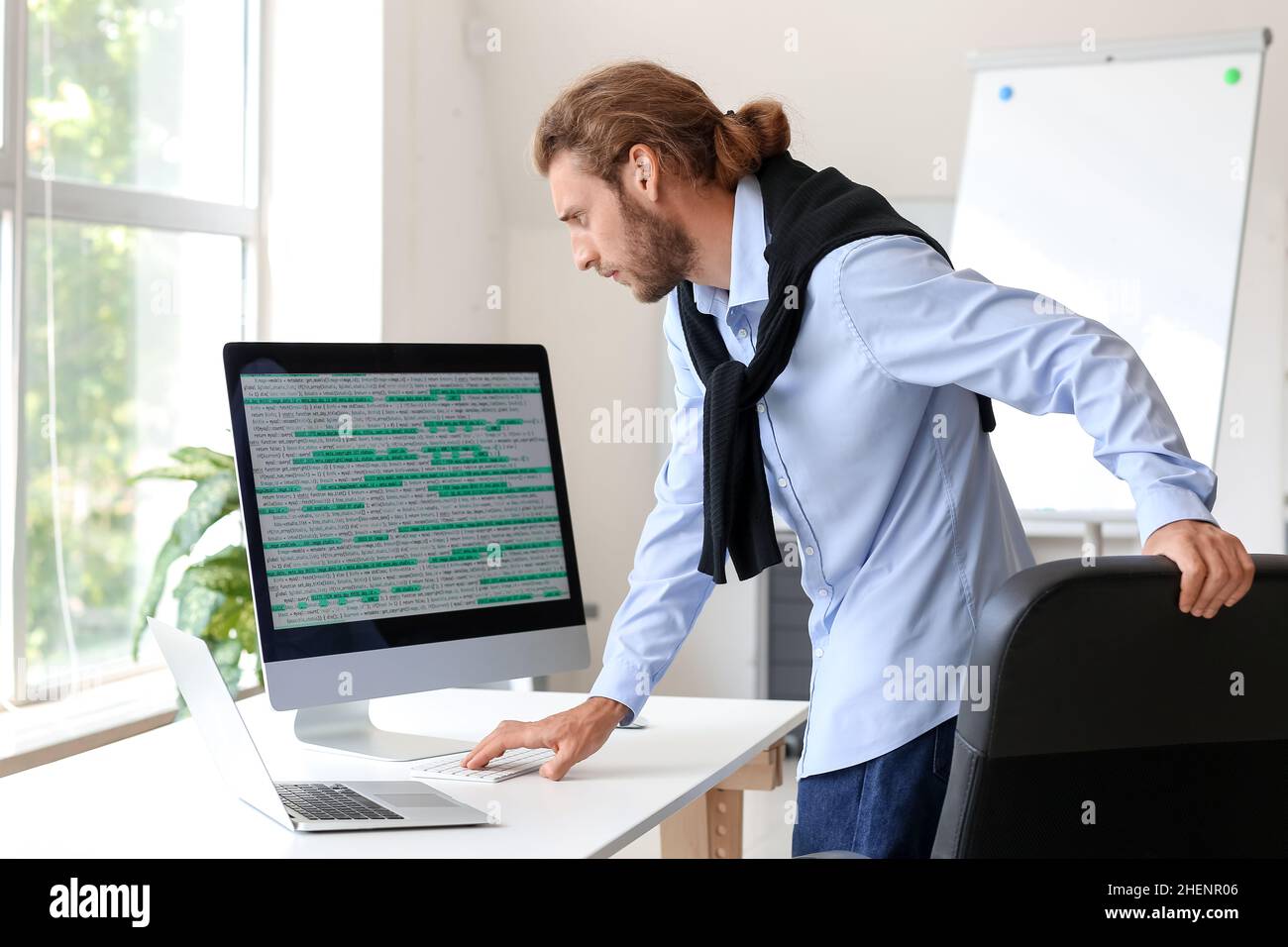 Male programmer working in office Stock Photo - Alamy
